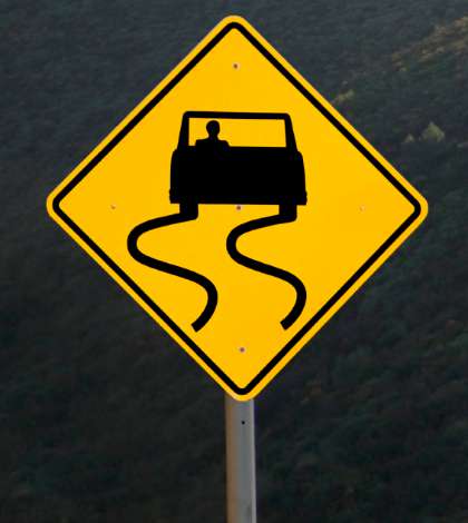 A slippery when wet road sign. - Today's General Counsel